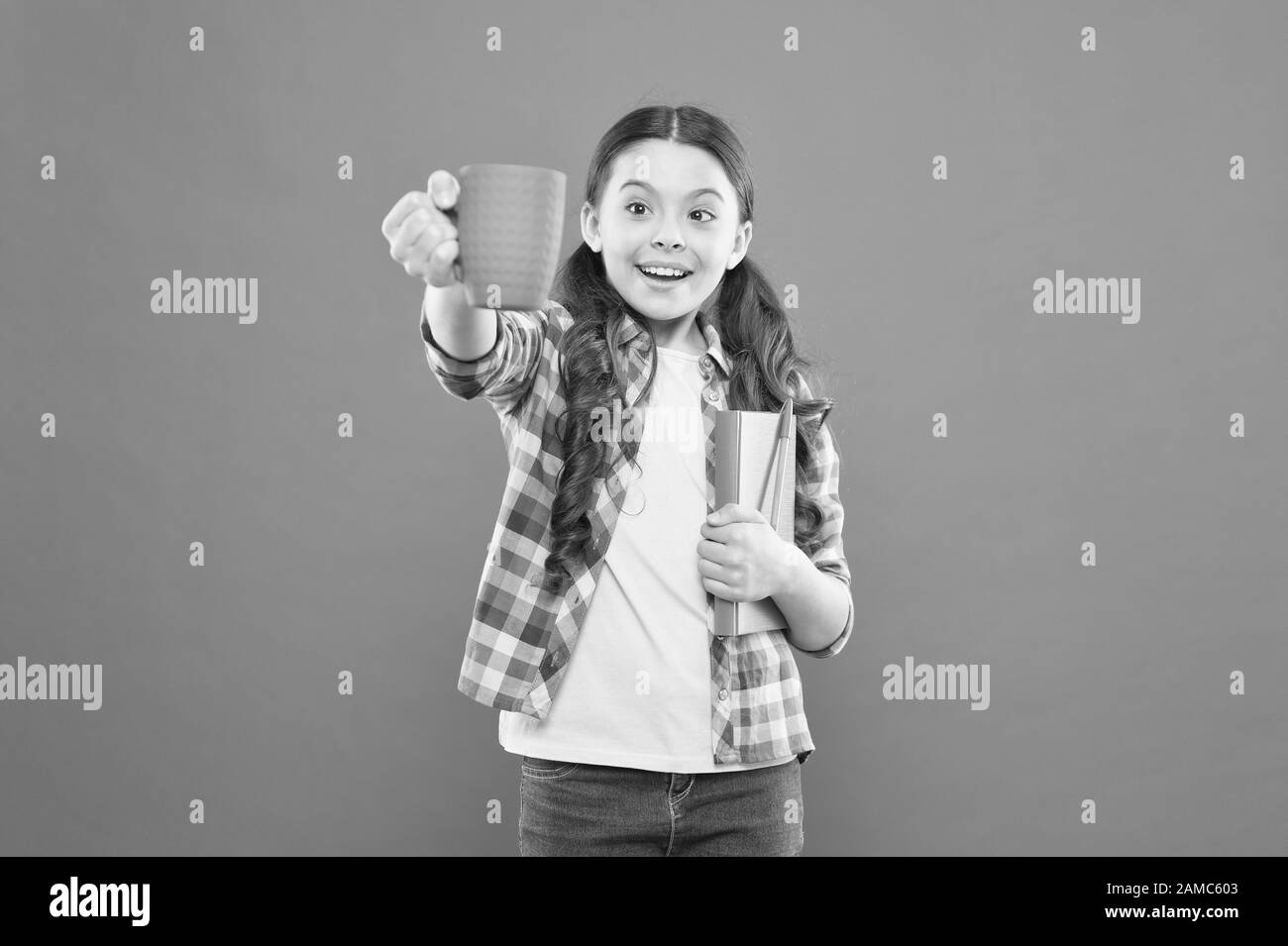 Help yourself. Cute schoolgirl enjoying school break on orange ...