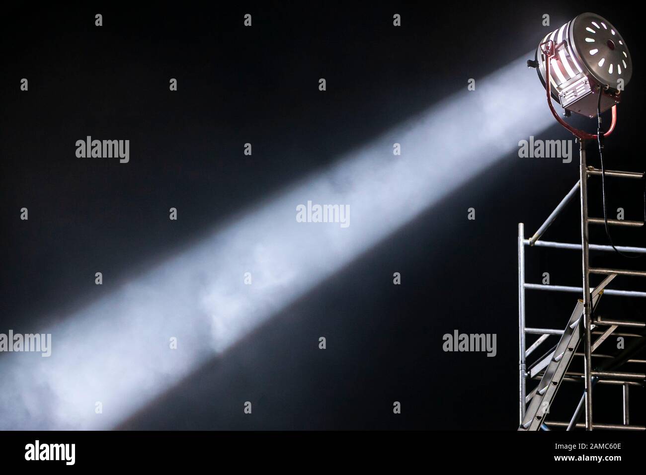 strong and focused diagonal light ray from a movie lighting spotlight ...