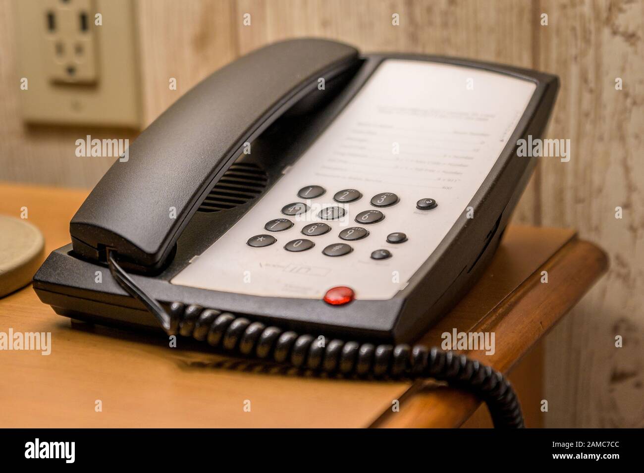 A somewhat old-fashioned landline tabletop touchtone phone with push ...