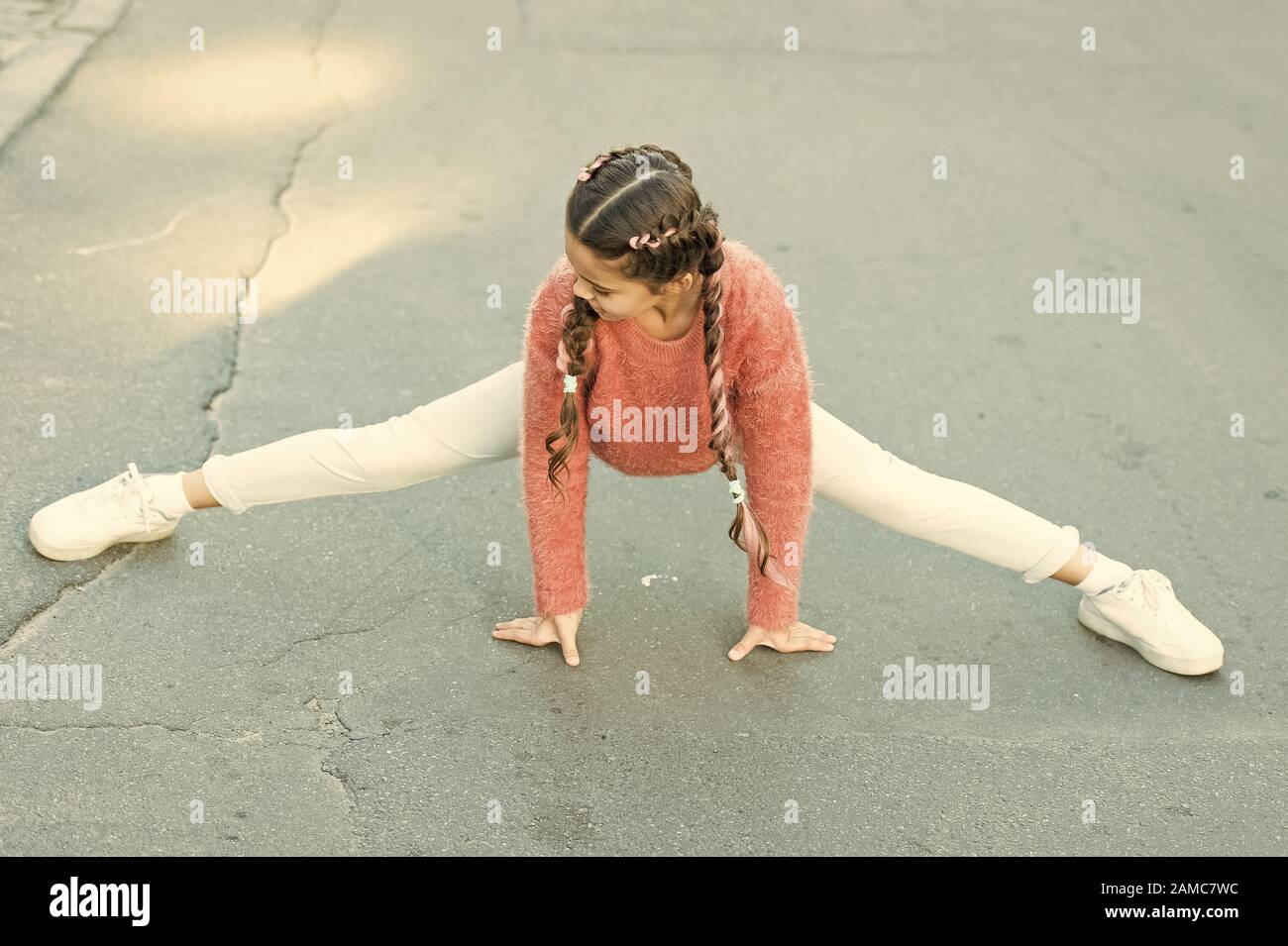 Stretching exercises to prevent sports injuries. Small gymnast outdoor ...