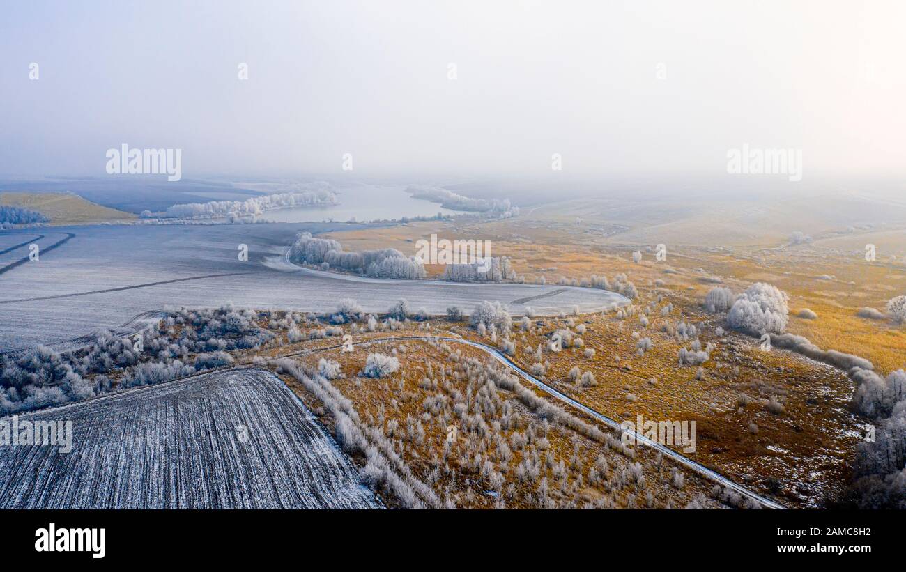 Snowy meadow with forest strips and empty agrarian fields. Winter ...