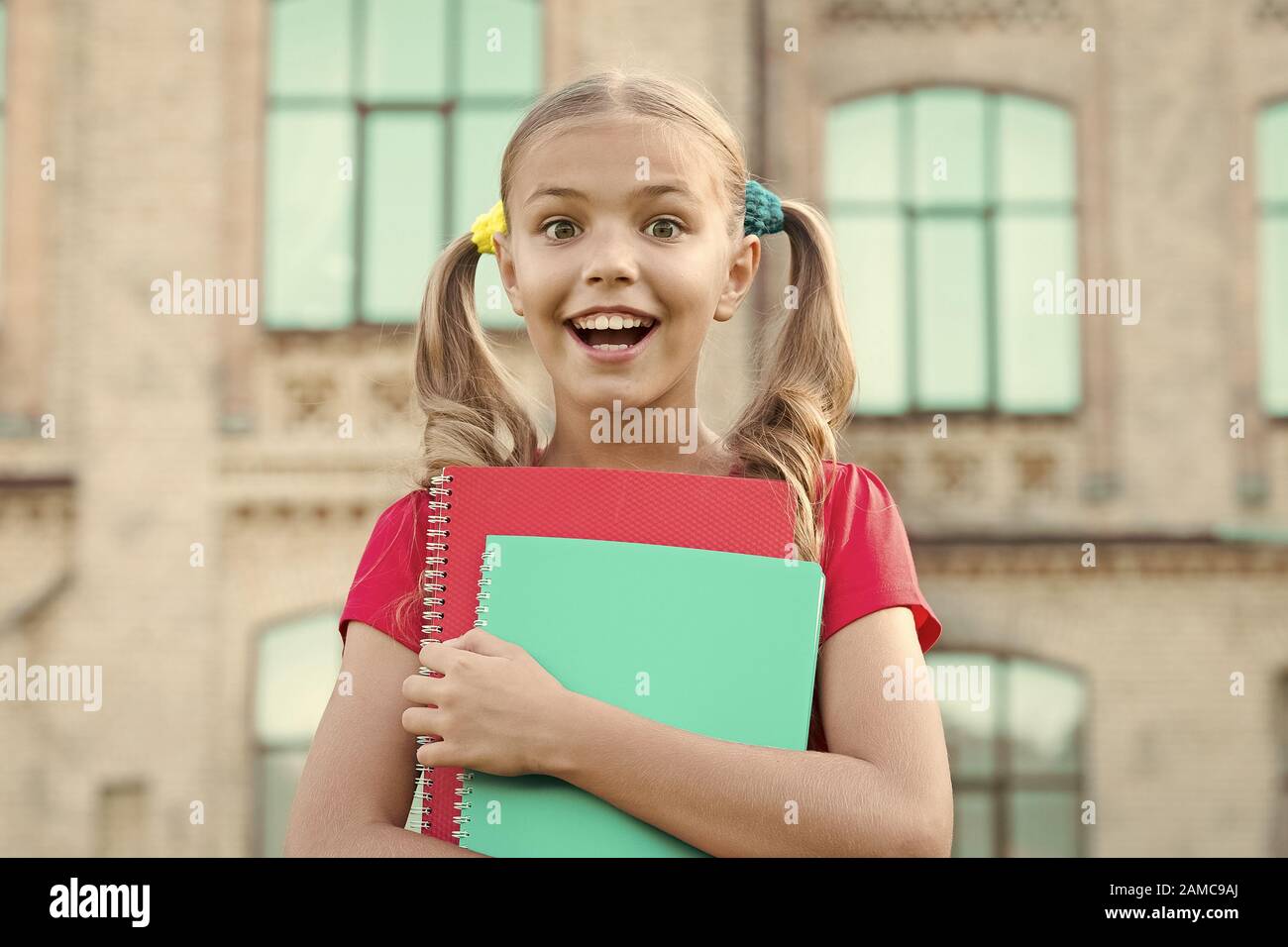 The books shes always dreamed of. Happy little girl hold books with ...