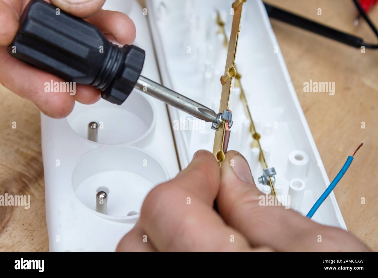 Installation of electrical cables to the manifold. The electrician ...