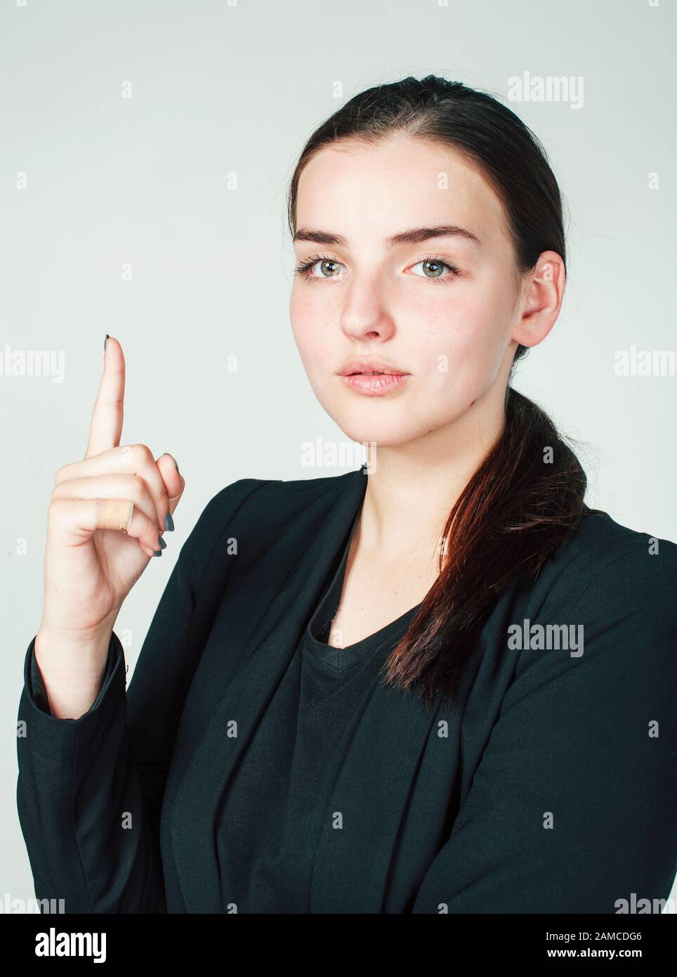 young pretty girl pointing and gesturing on white background, business ...