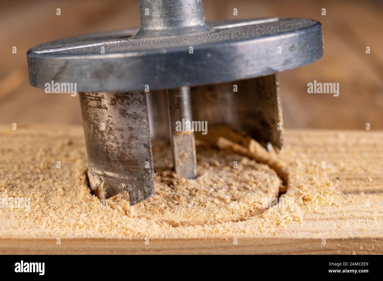Wood hole saw and raw board. Making holes in raw wood. Place ...