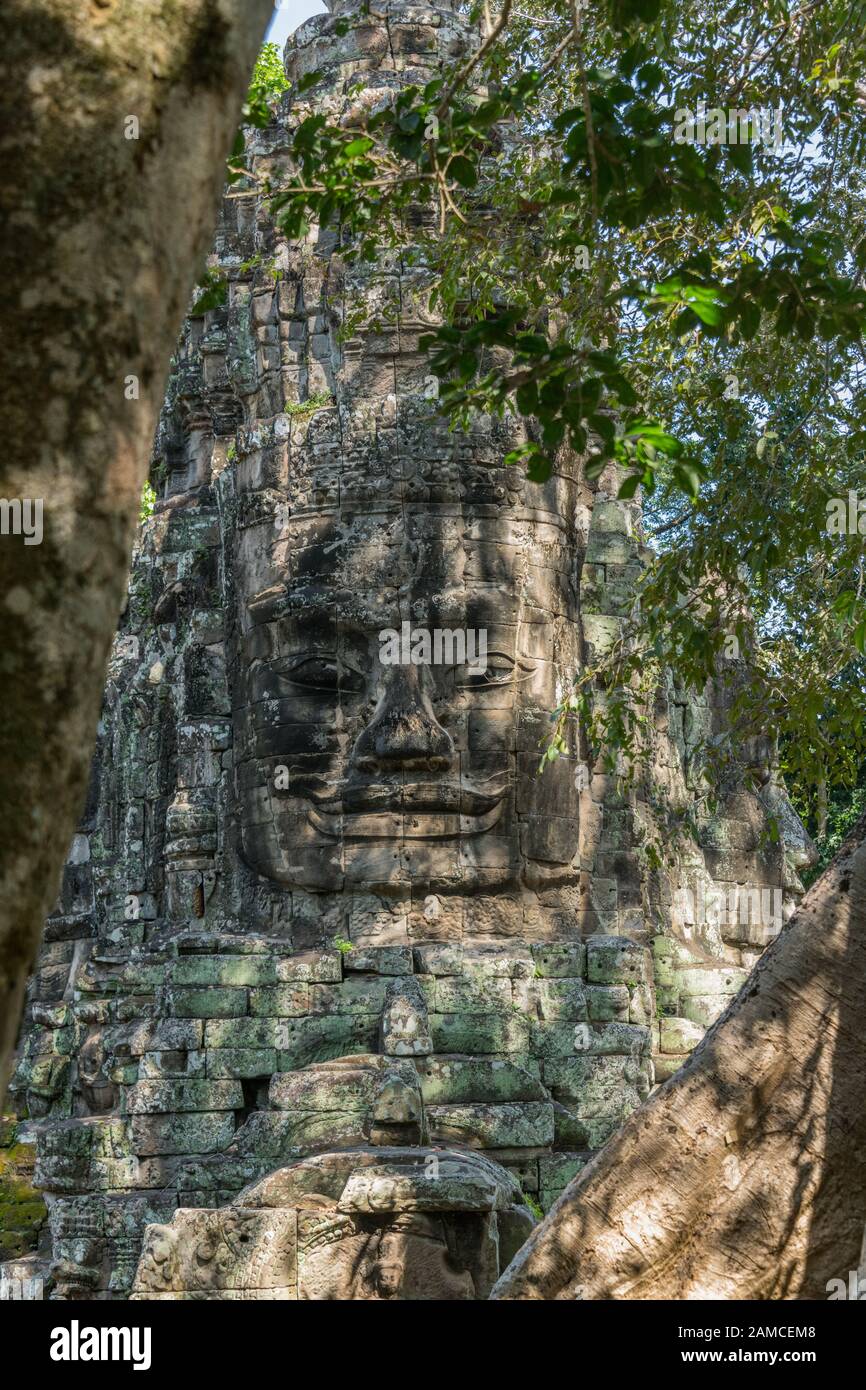 An ancient statue on top of a gate at Ankor Thom in Cambodia Stock ...
