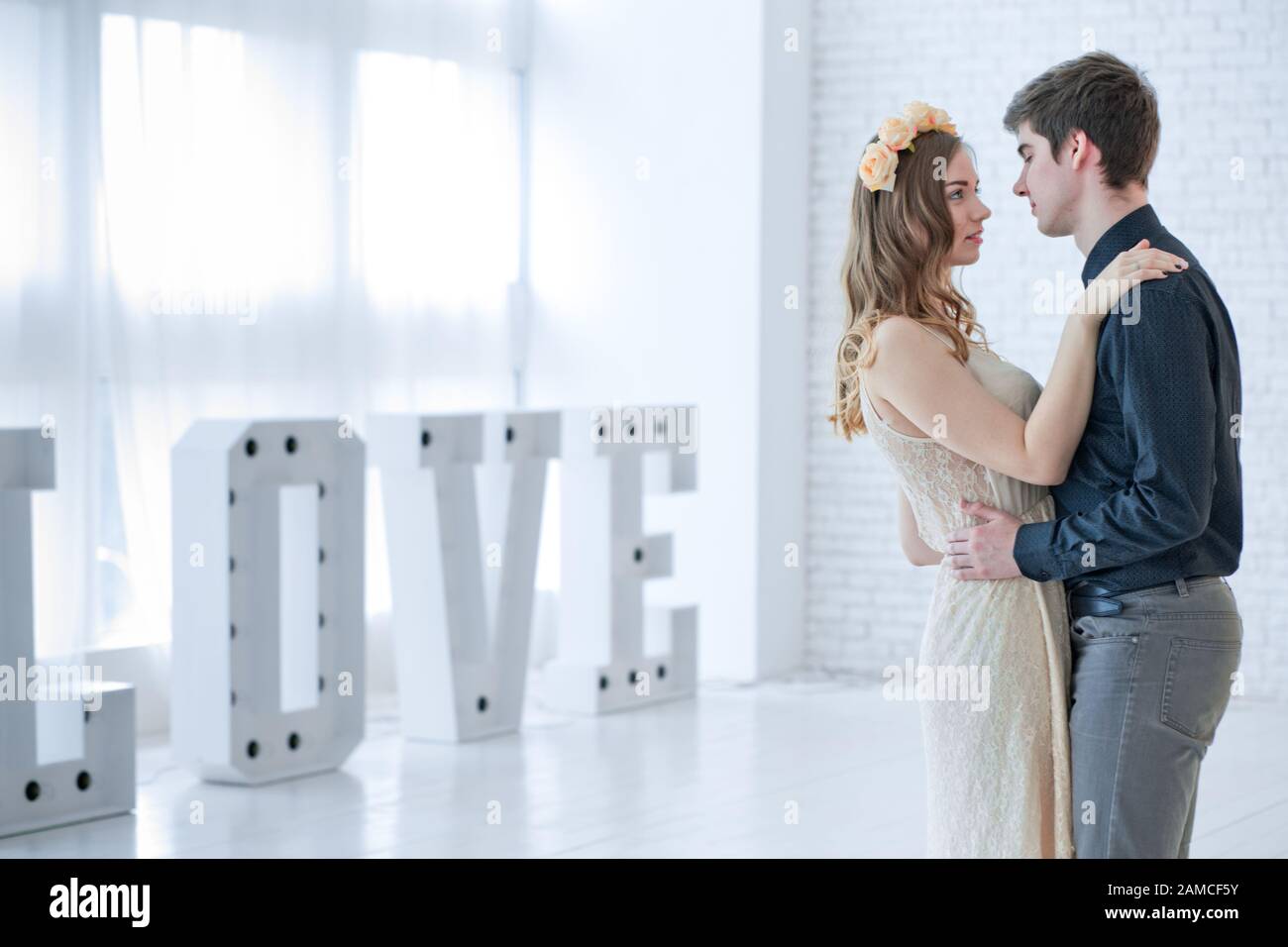 Yellow and blue hives on apiary under large flowering acacia tree ...