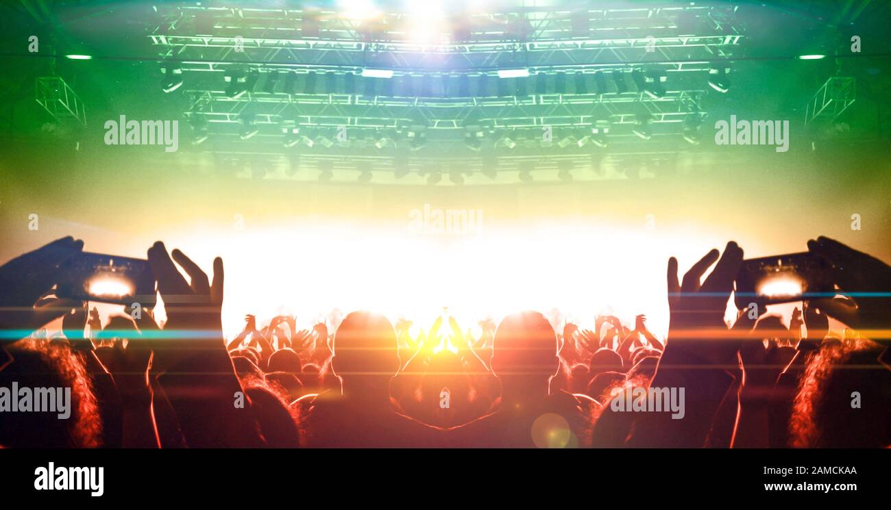 Concert stage shot from inside a concert hall with many people ...