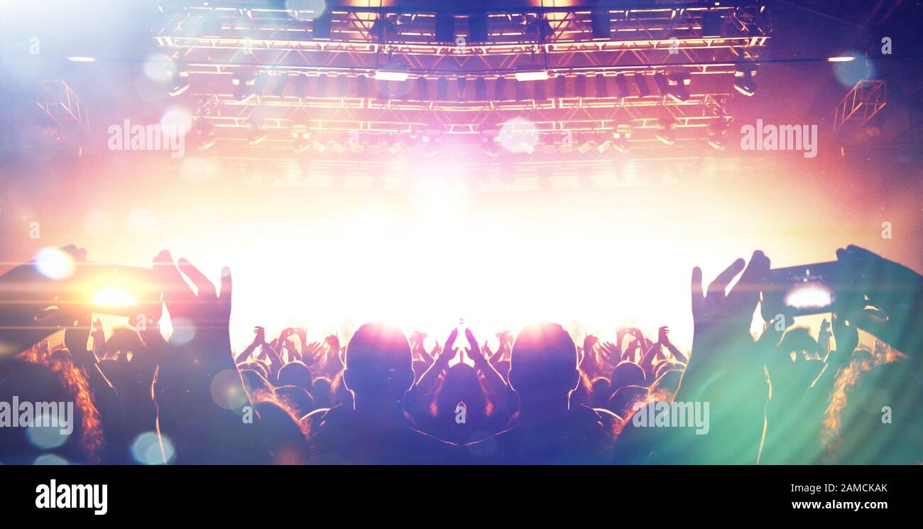 Concert stage shot from inside a concert hall with many people ...