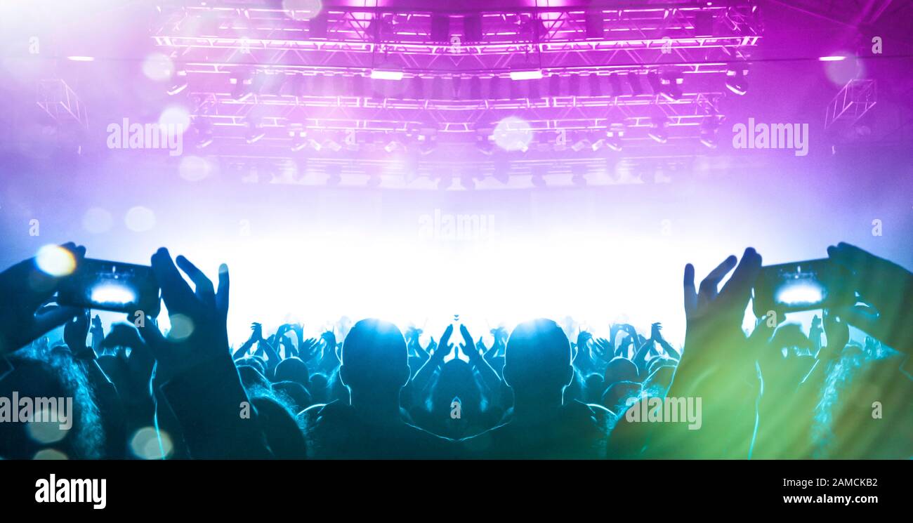 Concert stage shot from inside a concert hall with many people ...