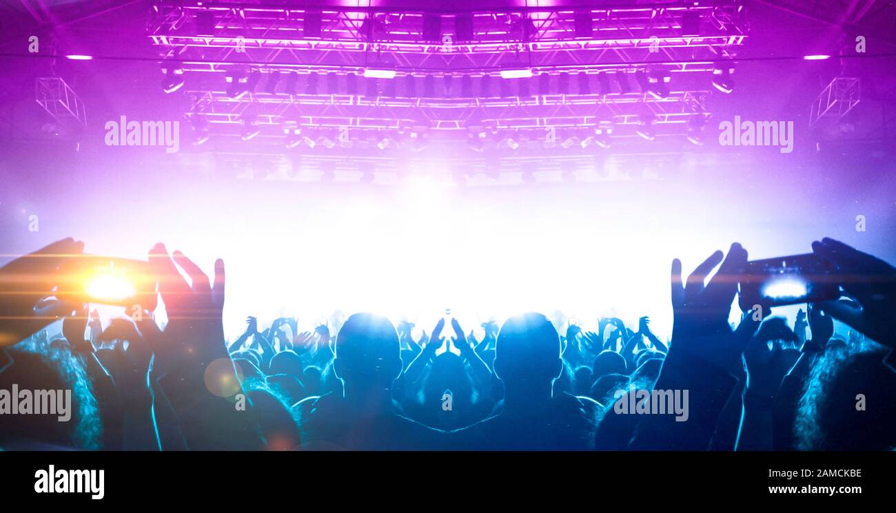 Concert stage shot from inside a concert hall with many people ...