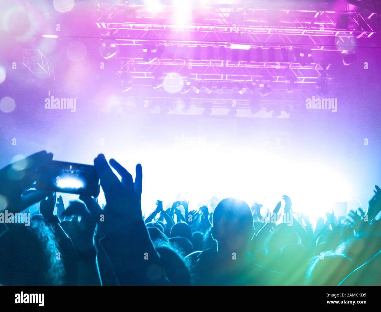 Concert stage shot from inside a concert hall with many people ...