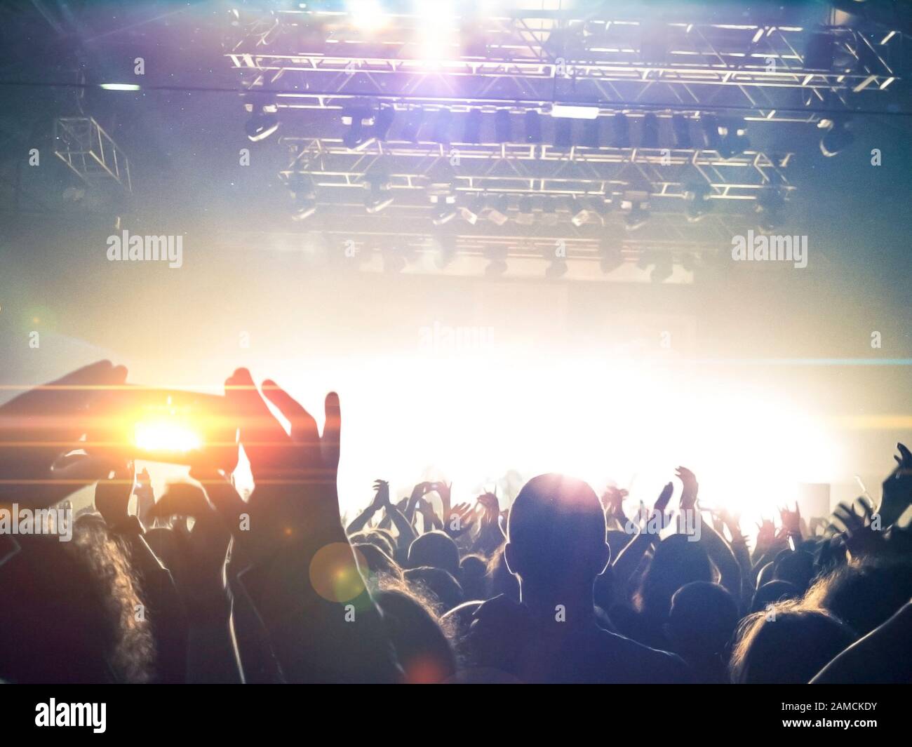 Concert stage shot from inside a concert hall with many people ...