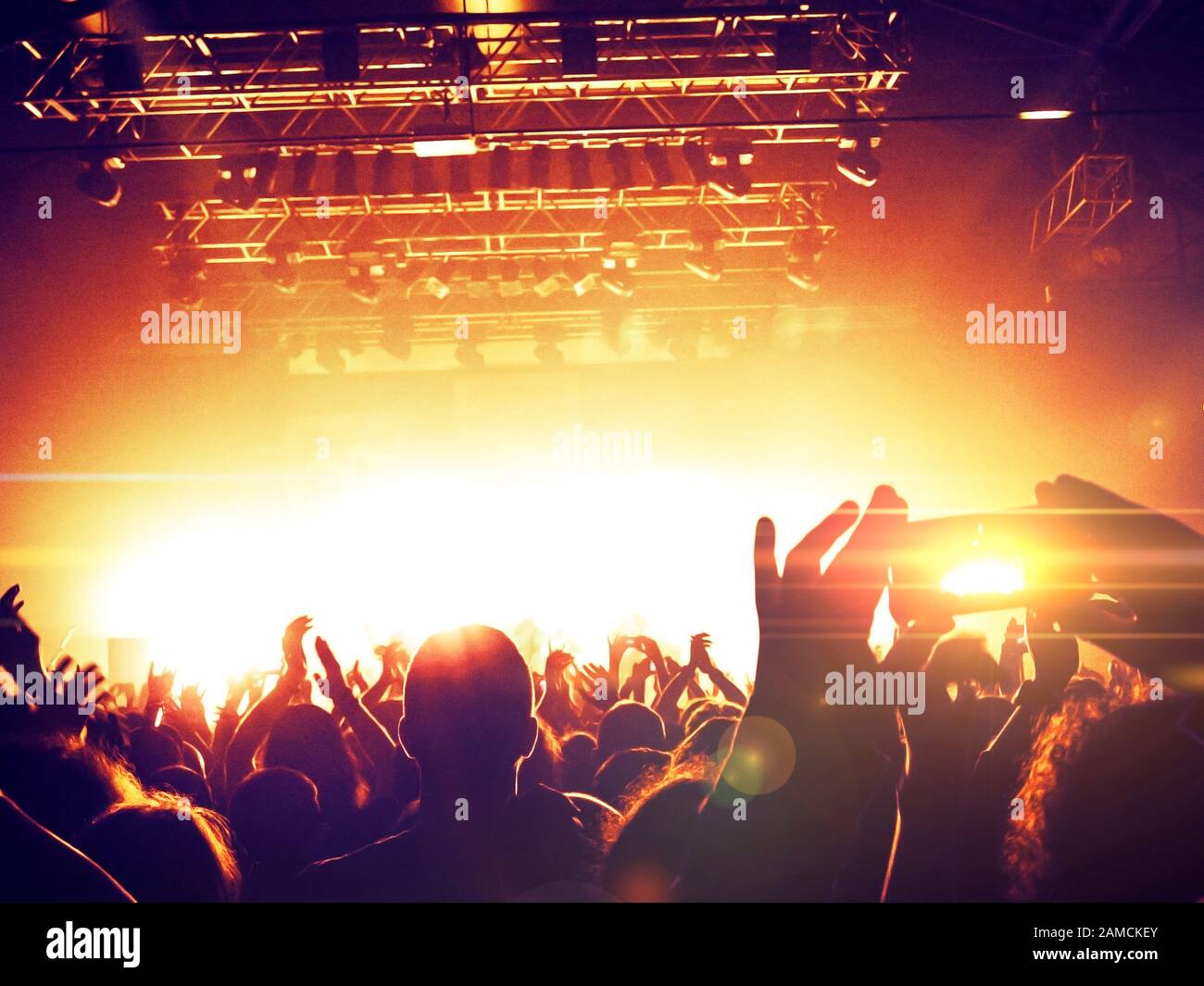 Concert stage shot from inside a concert hall with many people ...