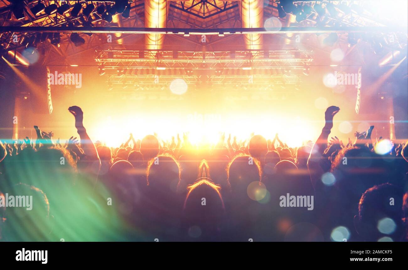 Concert stage shot from inside a concert hall with many people ...