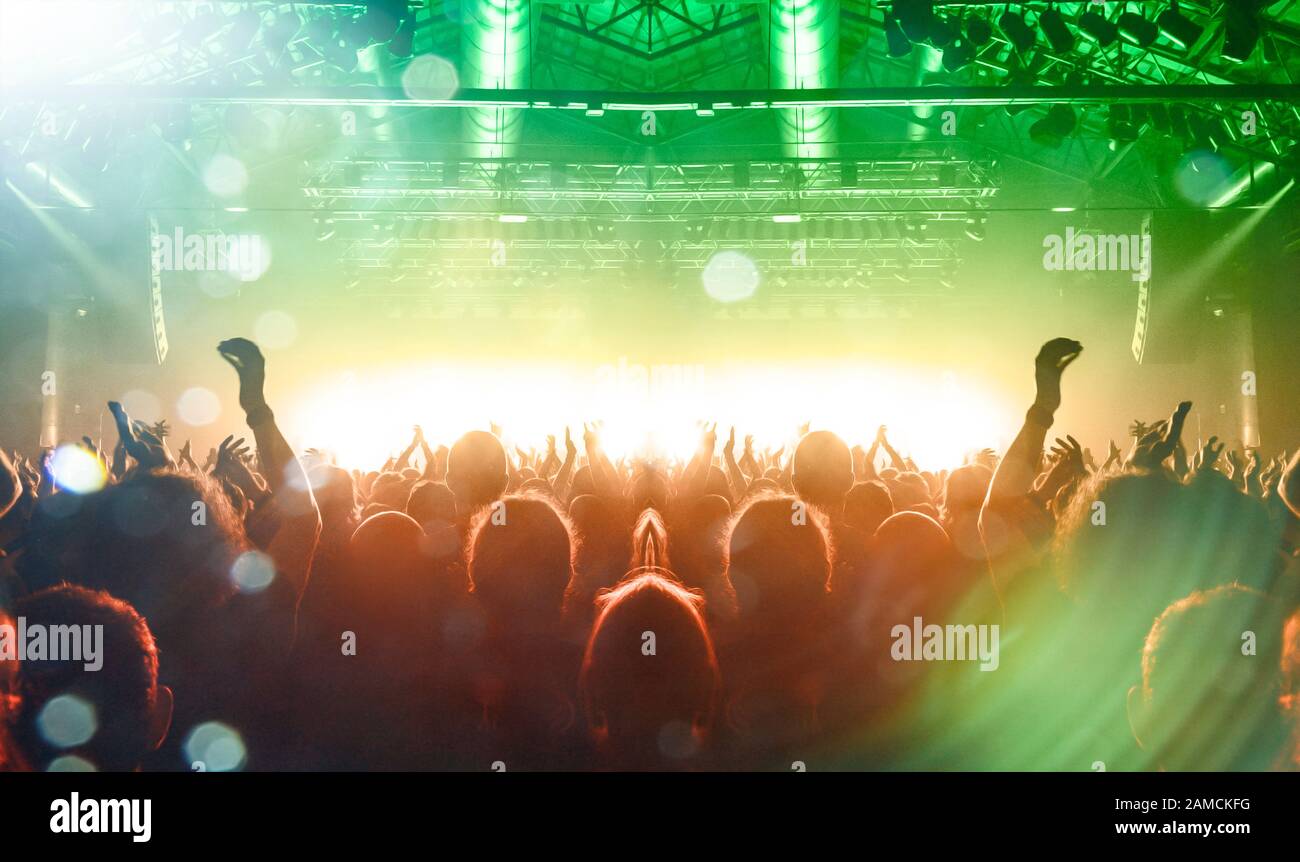 Concert stage shot from inside a concert hall with many people ...