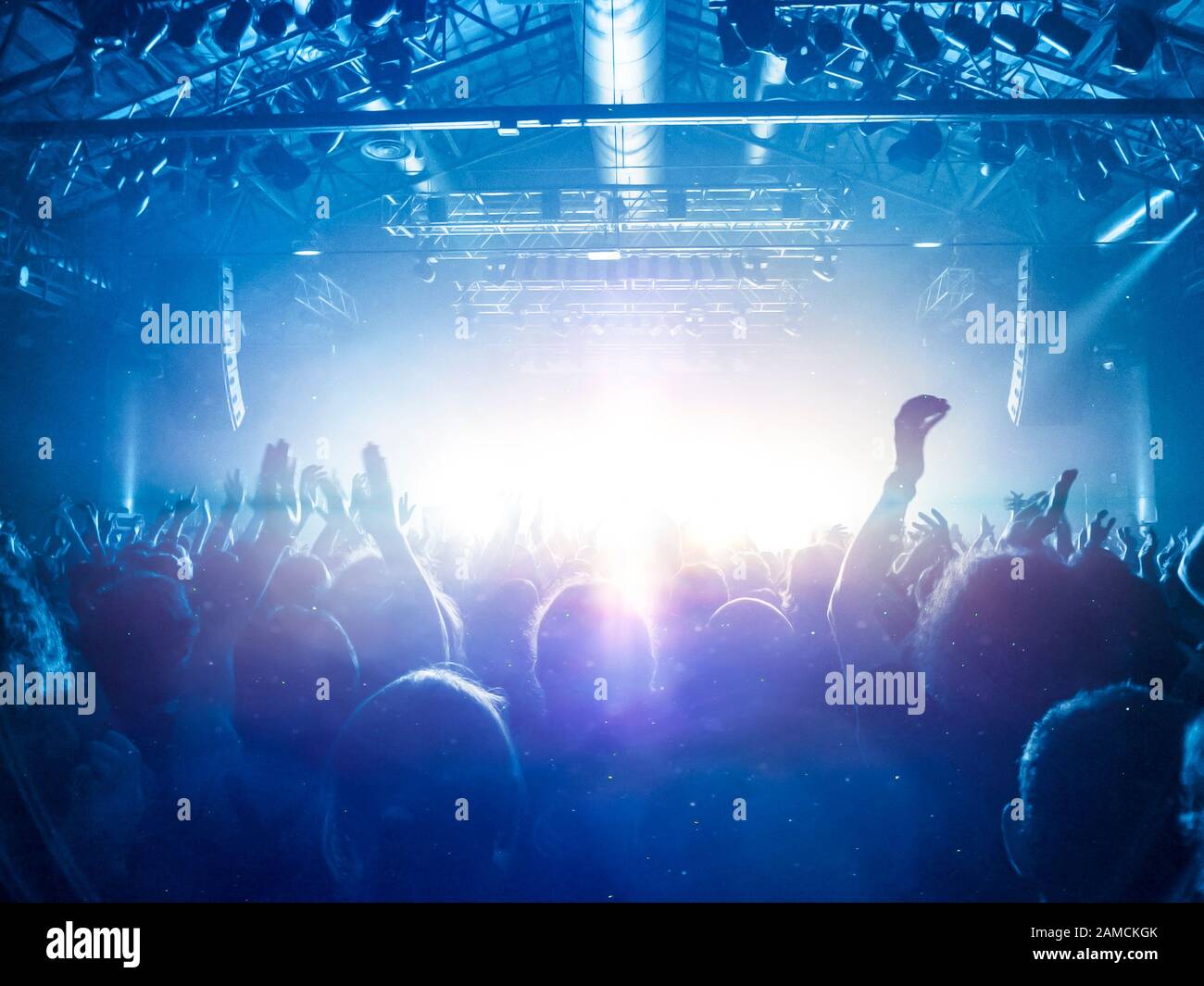 Concert stage shot from inside a concert hall with many people ...