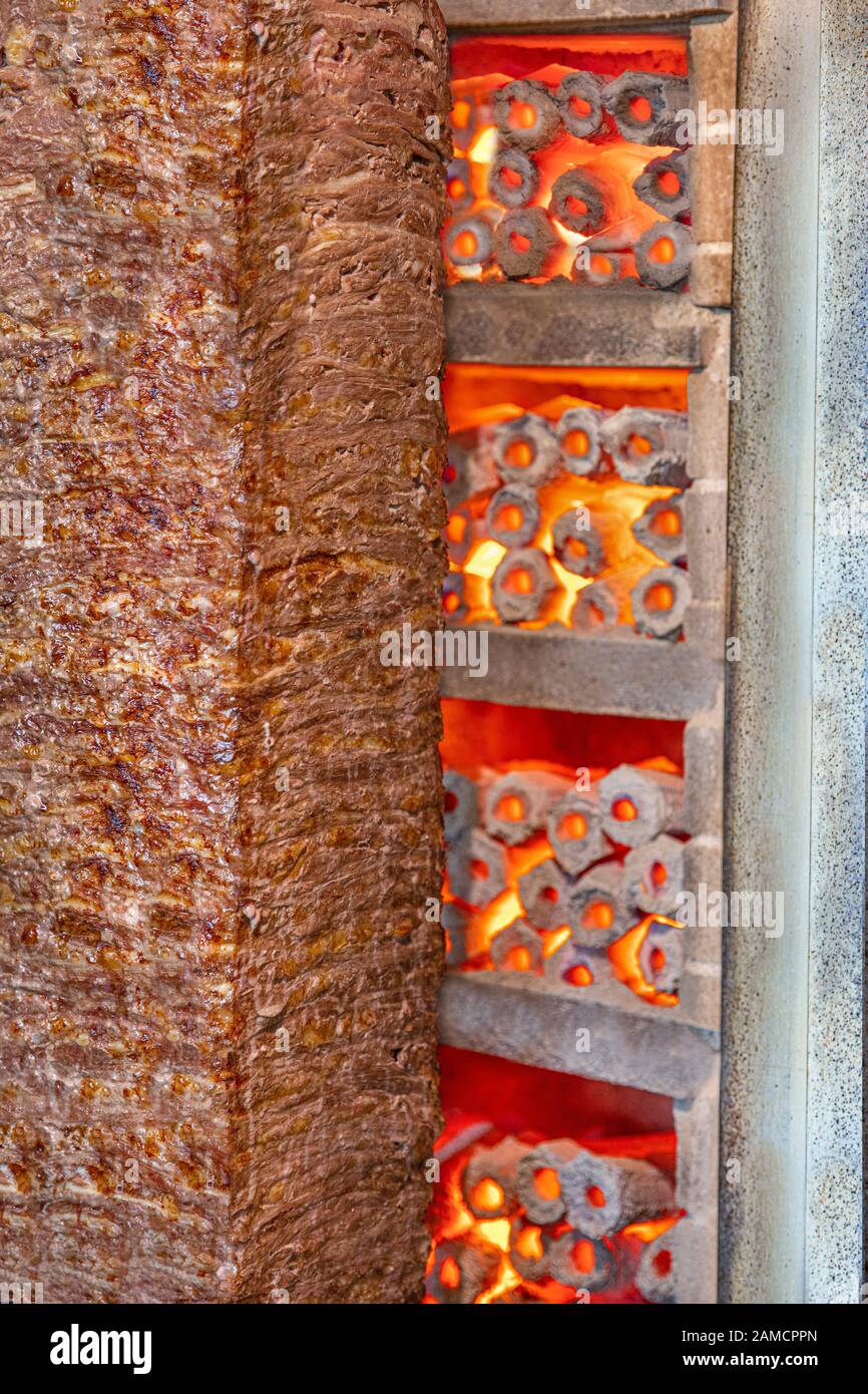 Traditional Turkish food Doner Kebab. Turkish doner kebab is being cut ...