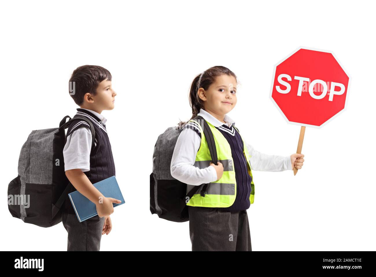 Schoolgirl and schoolboy wearing safety vests and holding a stop sign ...