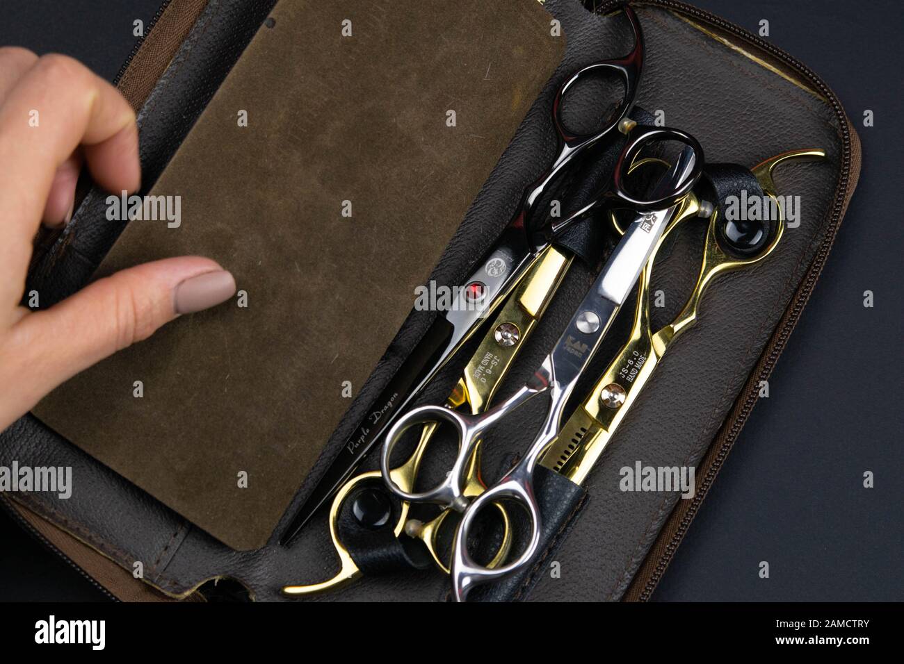 Composition of hairdressers instruments on black textured background ...