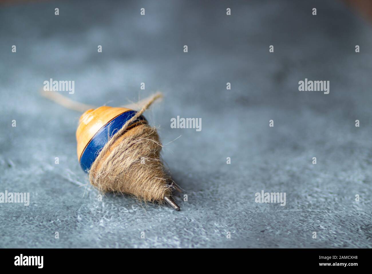 Classic wooden spinning top toy with string Stock Photo - Alamy