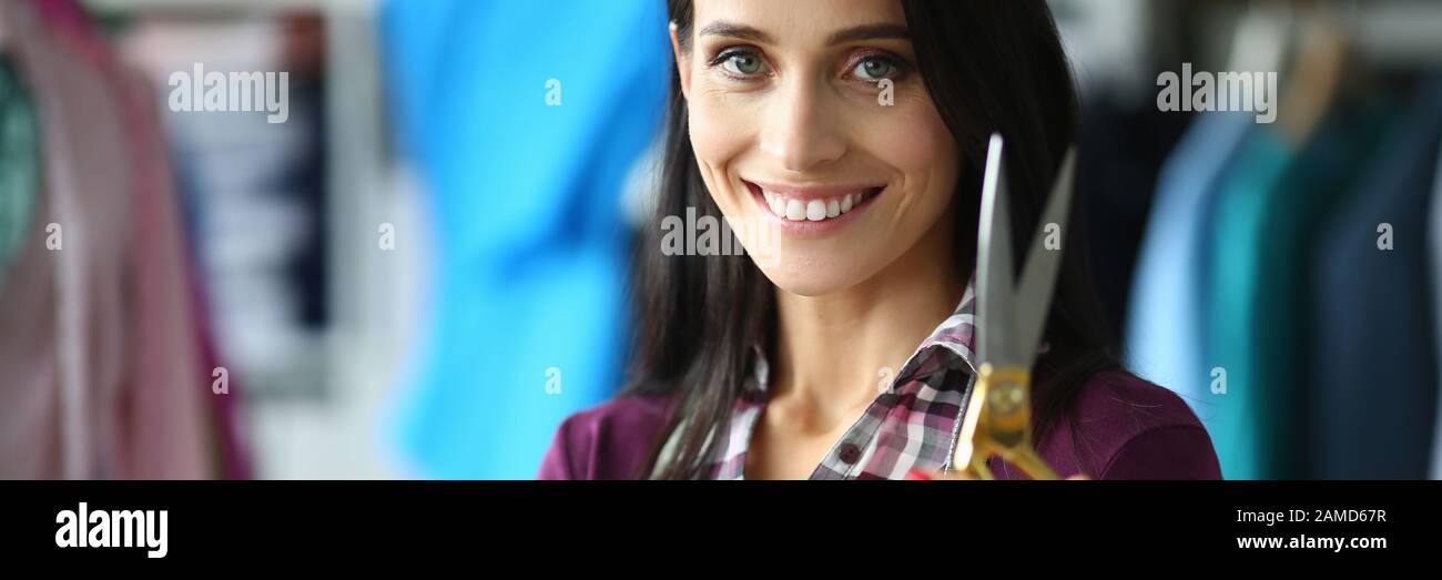 Pretty tailor with scissors Stock Photo - Alamy
