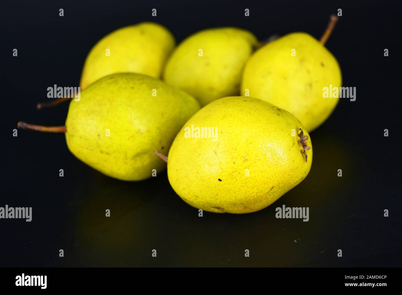 Bright tasty juicy pears of green, red and yellow color are located on ...