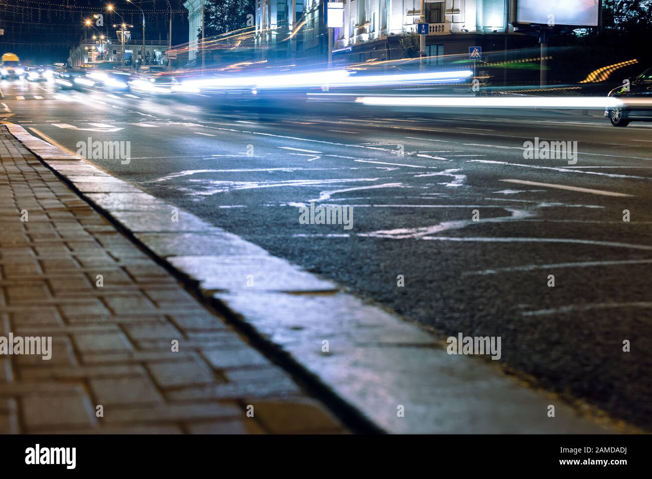 street traffic at night. bright light trails illuminating the road ...