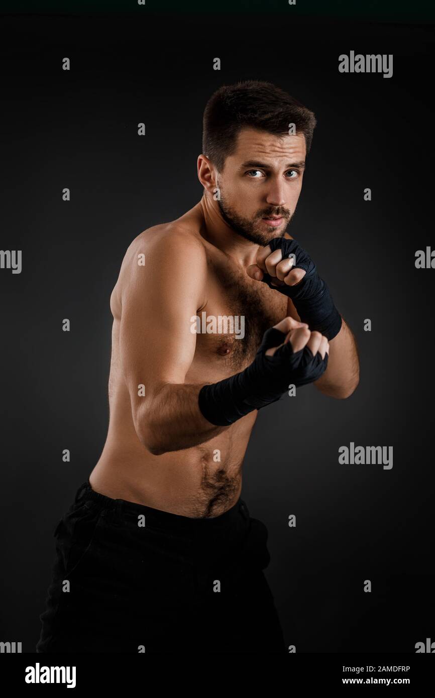 boxer man with bandage on hands training before fight and showing the ...