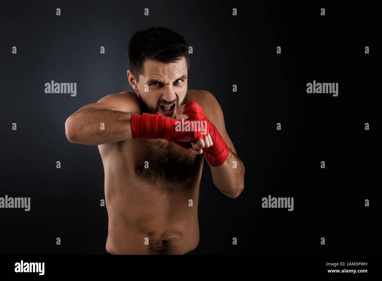 Sportsman boxer throwing a fierce and powerful punch. muscular man on ...