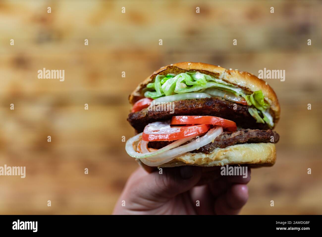 Hands holding burger hi-res stock photography and images - Alamy