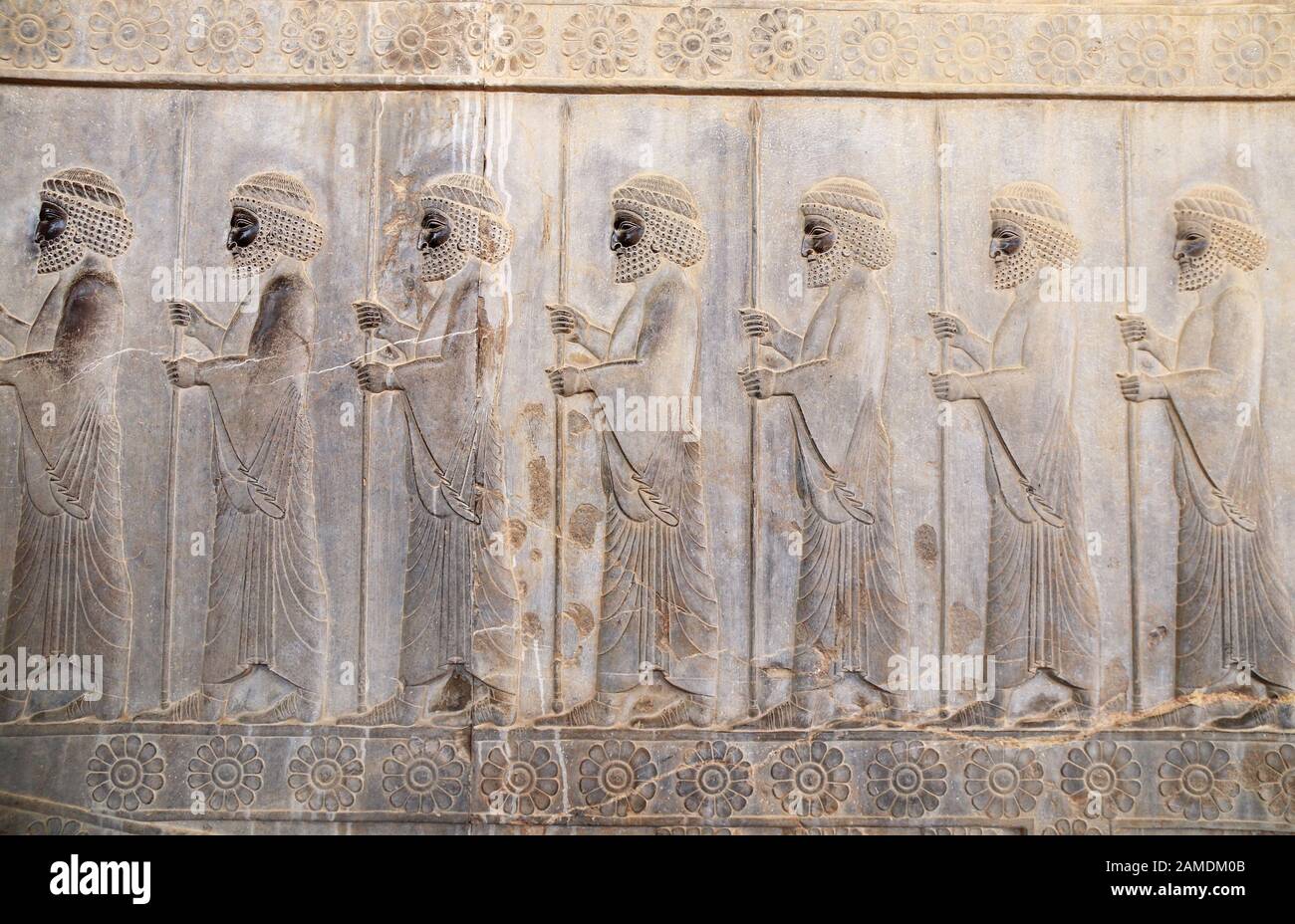 Ancient wall with bas-relief with assyrian warriors with spears ...