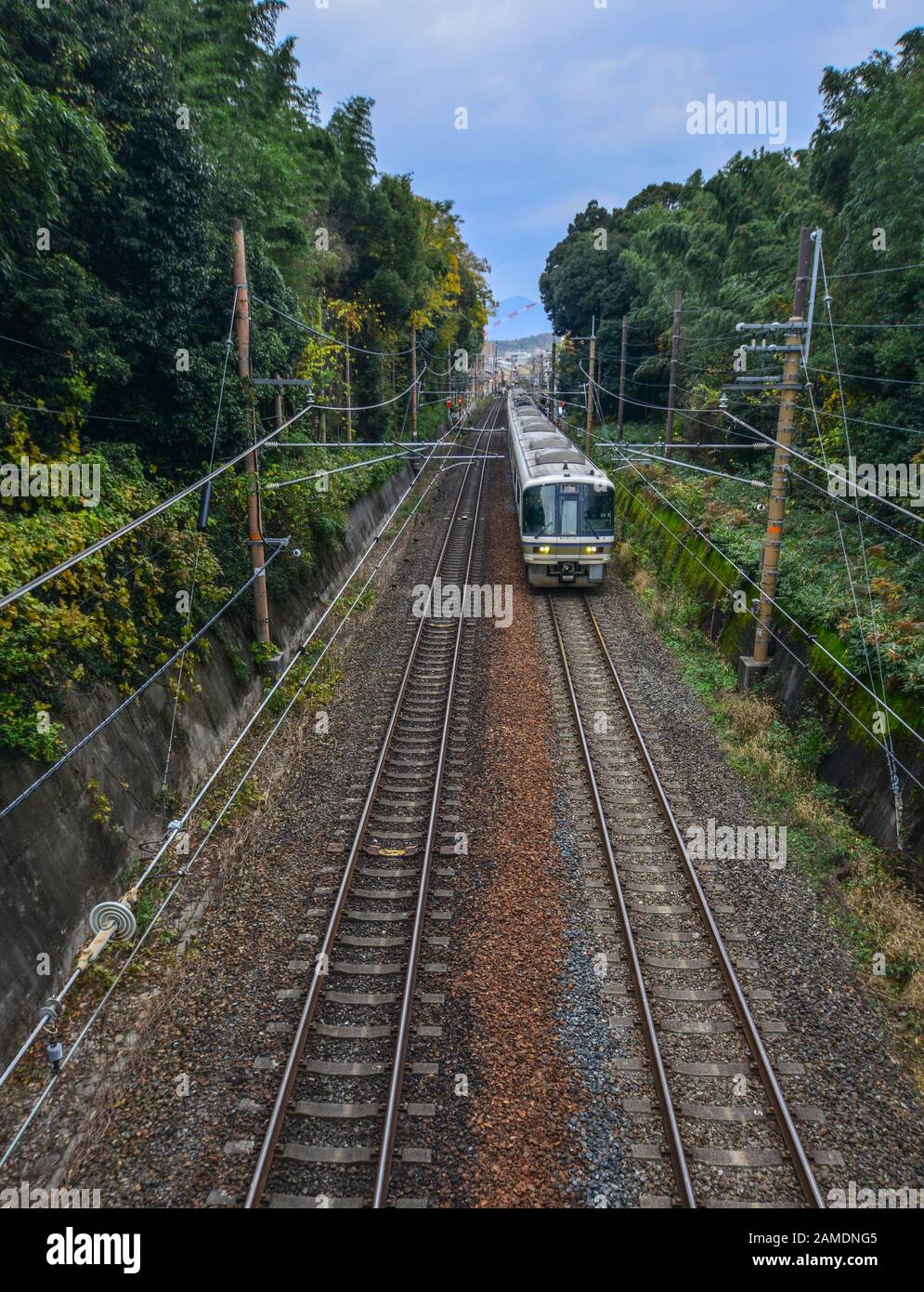 A train on rail track at Arashiyama district in Kyoto, Japan Stock ...