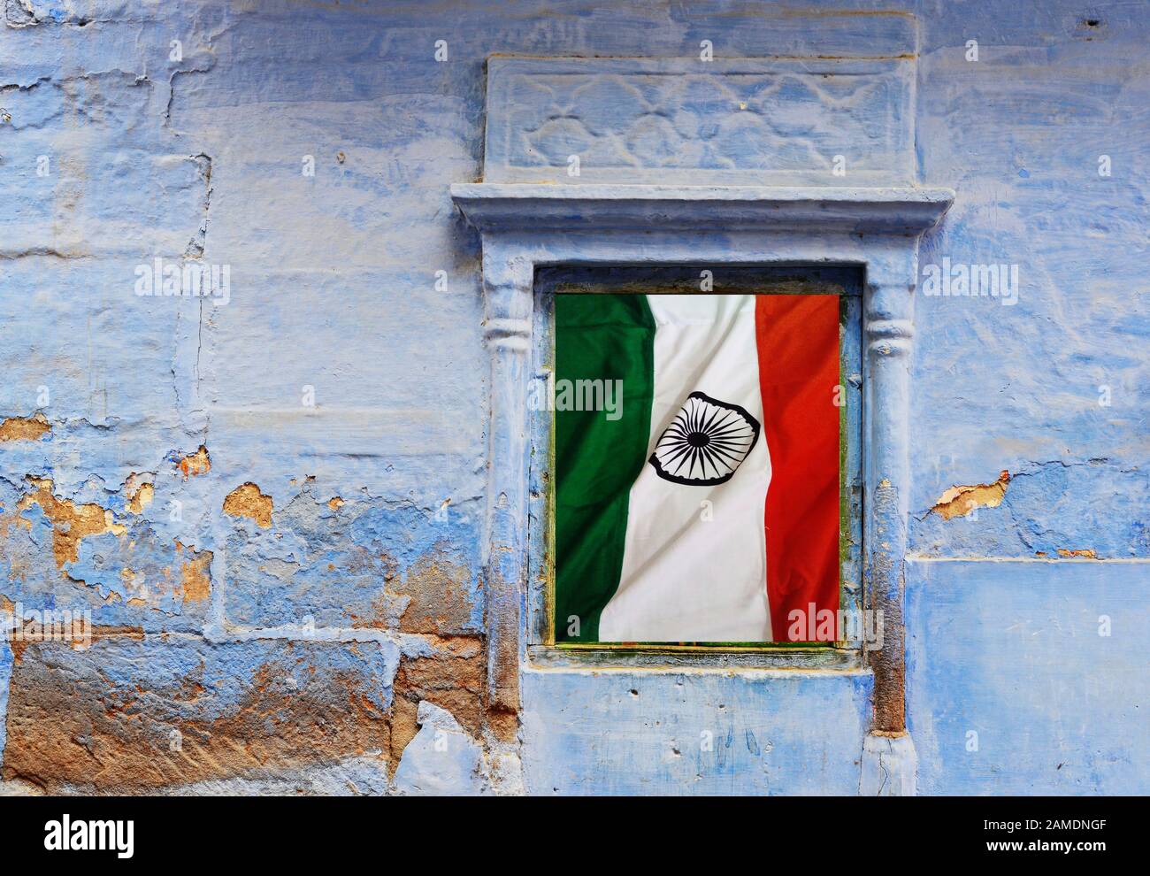 Blue wall with hanging Indian national flag of ancient building in Agra ...