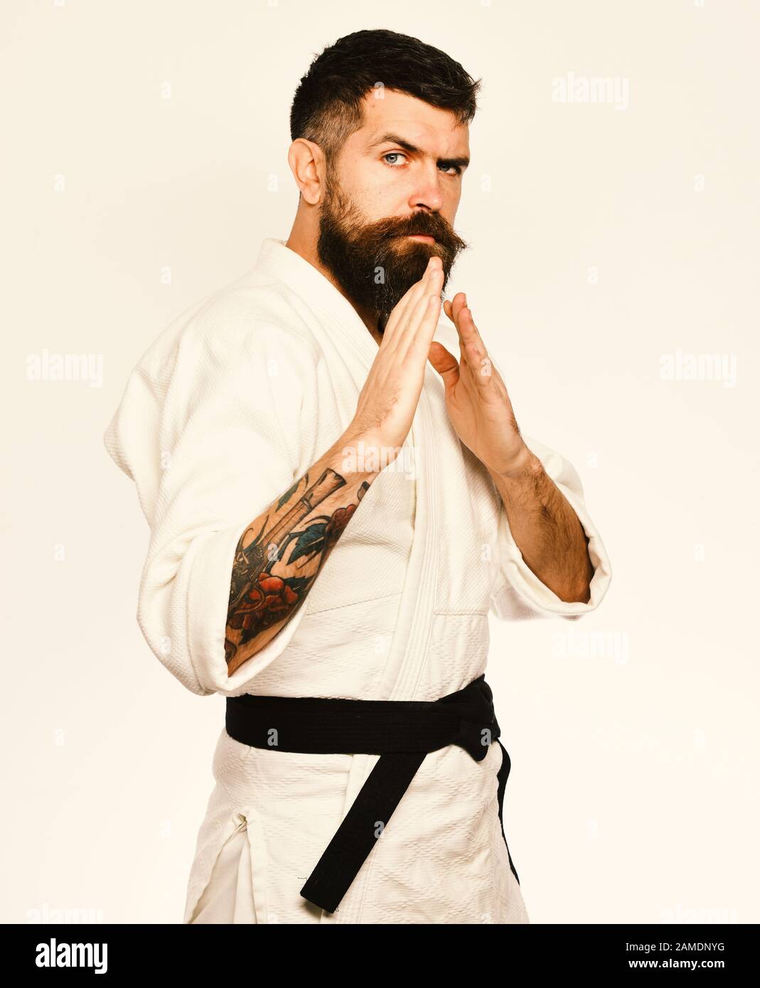 Man with beard in white kimono on white background. Taekwondo master ...