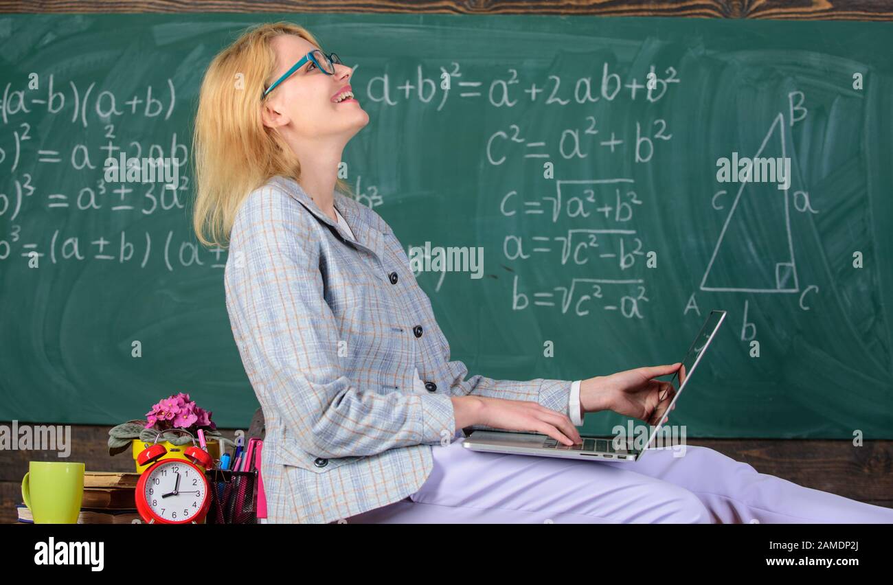 Teaching in non formal atmosphere. Woman teacher hold laptop sit table ... Teaching in non formal atmosphere. Woman teacher hold laptop sit table ...