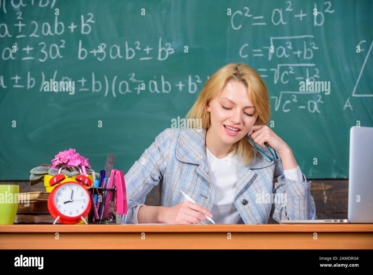 Teacher woman sit table chalkboard background. Excellent ...