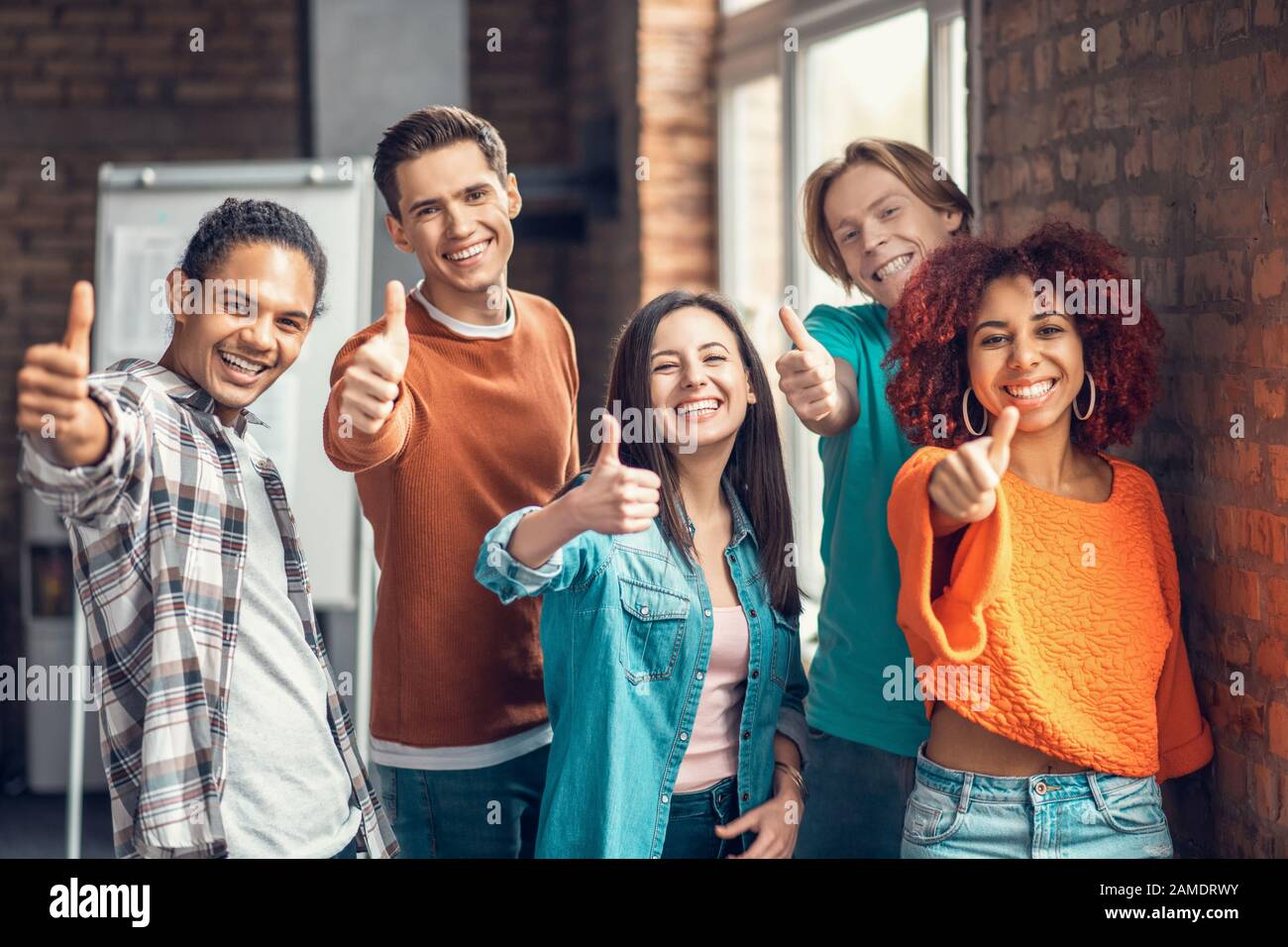Students showing thumbs up while feeling good after studying Stock ...