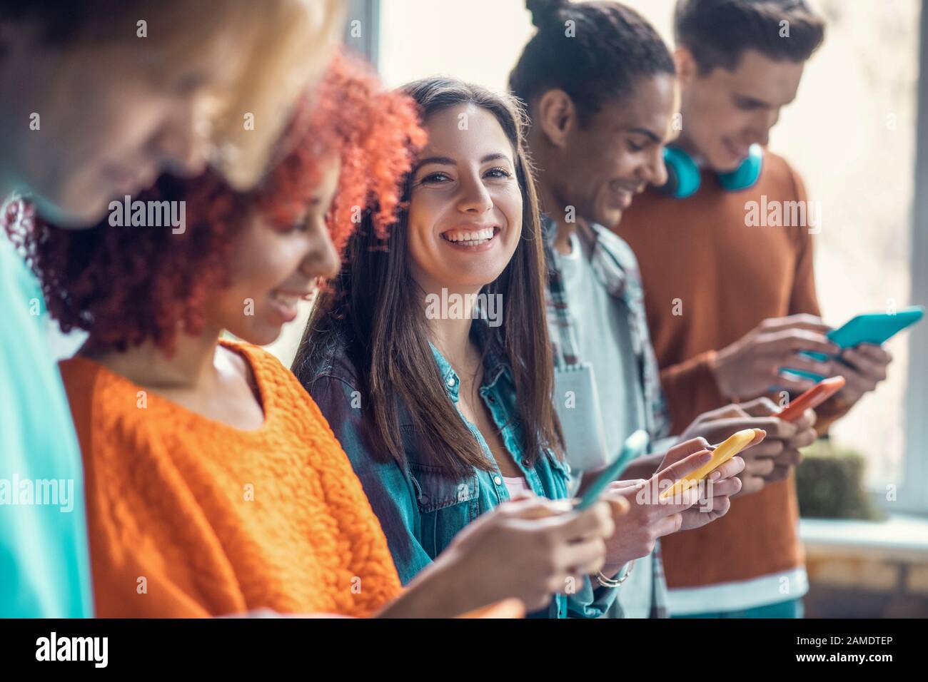 Students using phones and playing games while having break from study ...