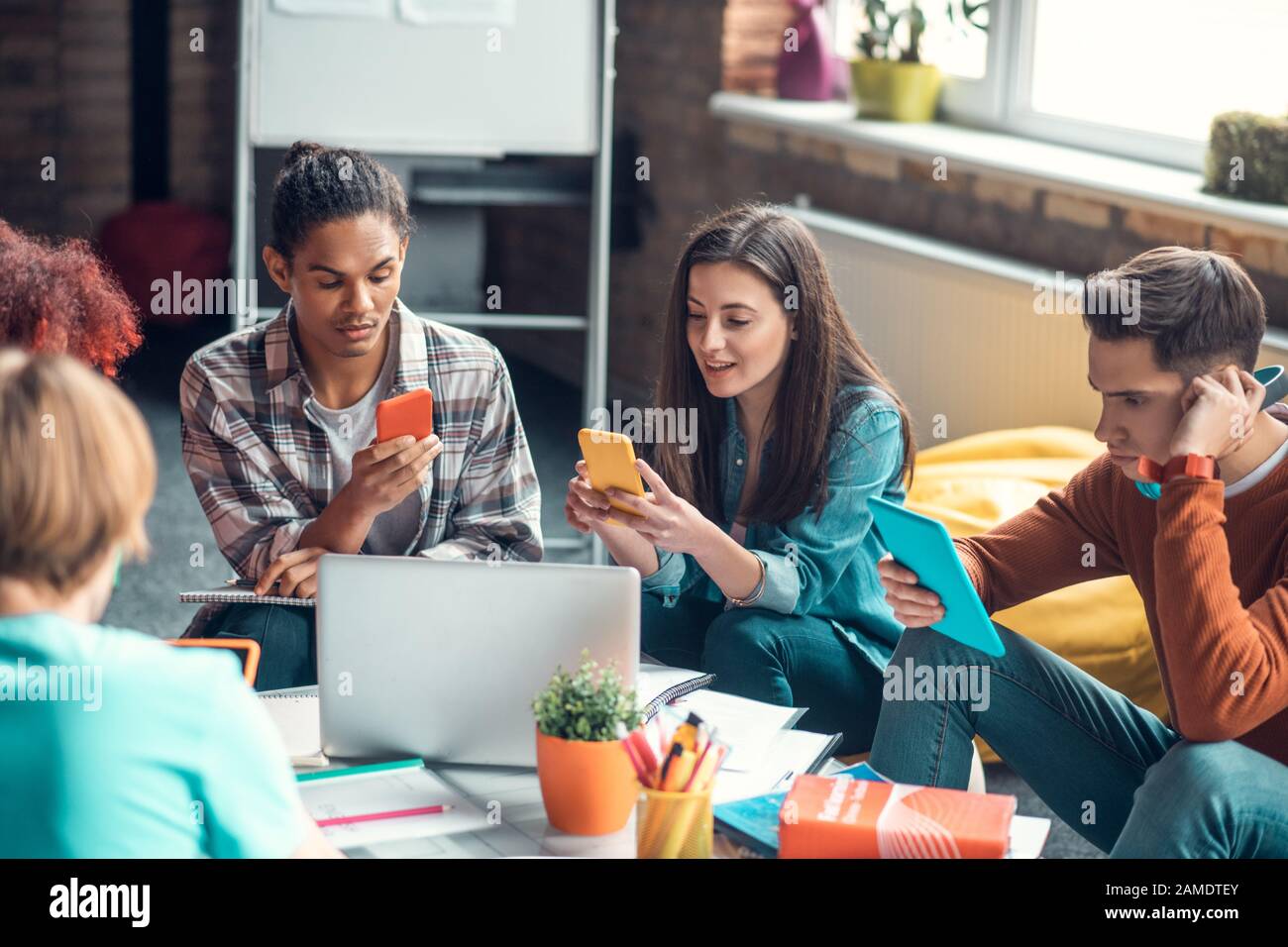Students using gadgets while searching for information Stock Photo - Alamy