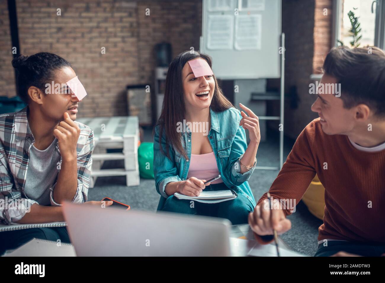 Beaming beautiful student feeling joyful while playing word game Stock ...