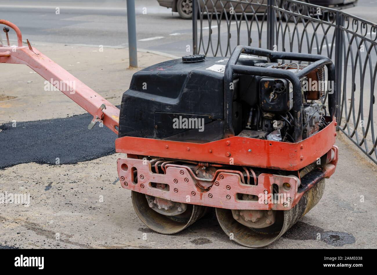Manual compact asphalt roller for tamping at a sidewalk. Equipment ...