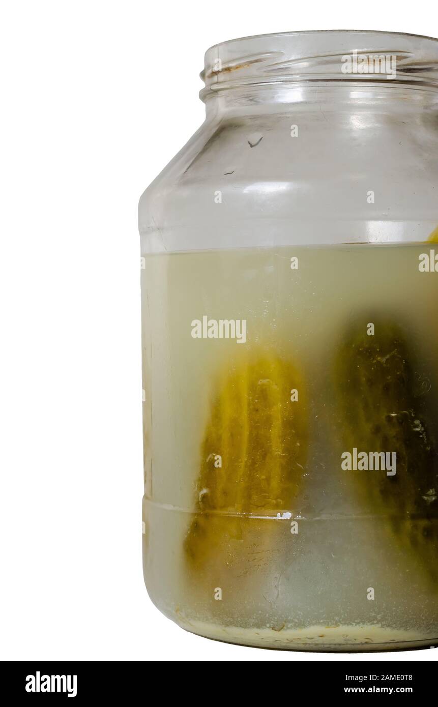 Half full jar with pickles and muddy pickle. Isolate on a white ...