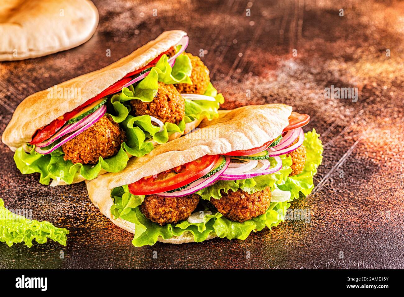 Falafel and fresh vegetables in pita bread on dark background Stock ...