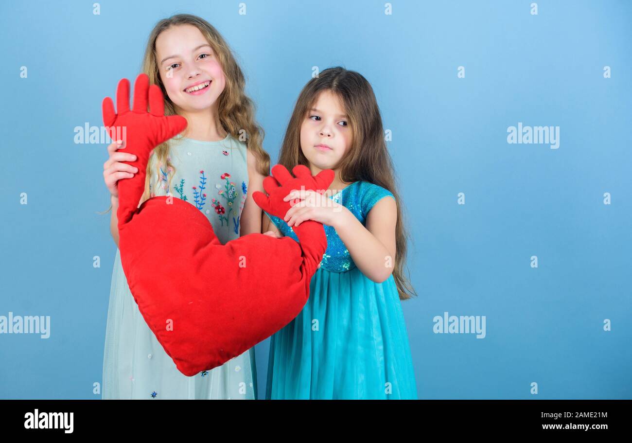 Heart matters. Cute kids holding heart shaped toy. Little girls holding ...