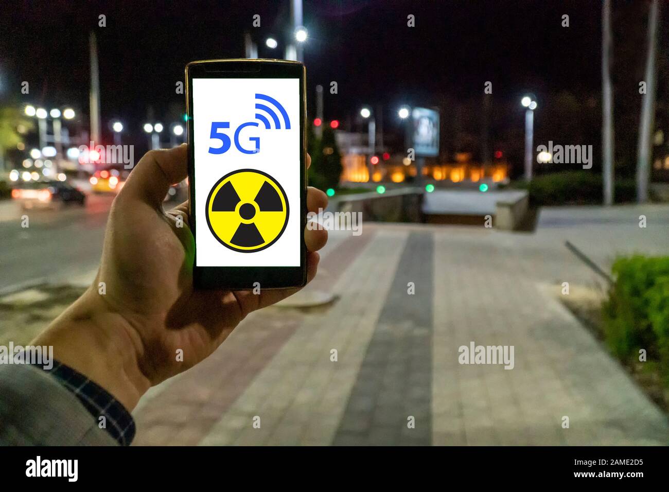 5g network danger on the street. Man holding smartphone with 5g and ...