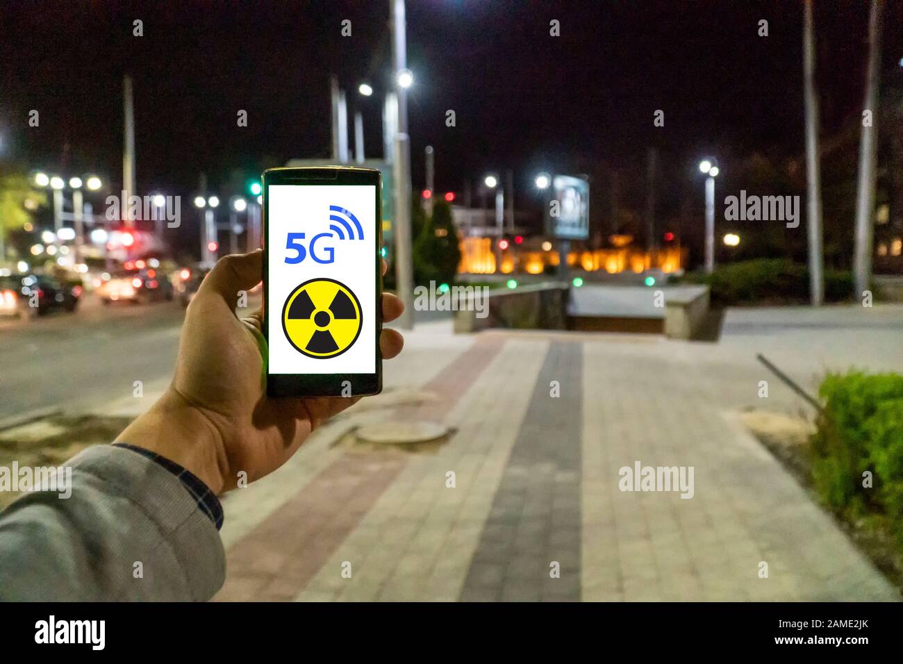 5g network danger on the street. Man holding smartphone with 5g and ...