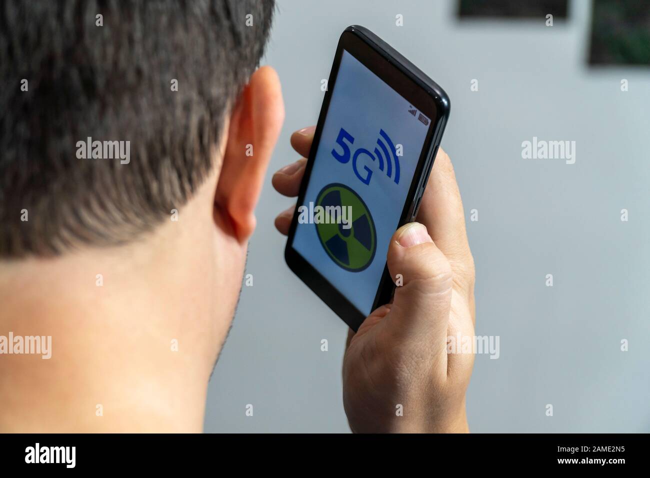 5g network danger concept. Man putting a smartphone to his ear. Back ...