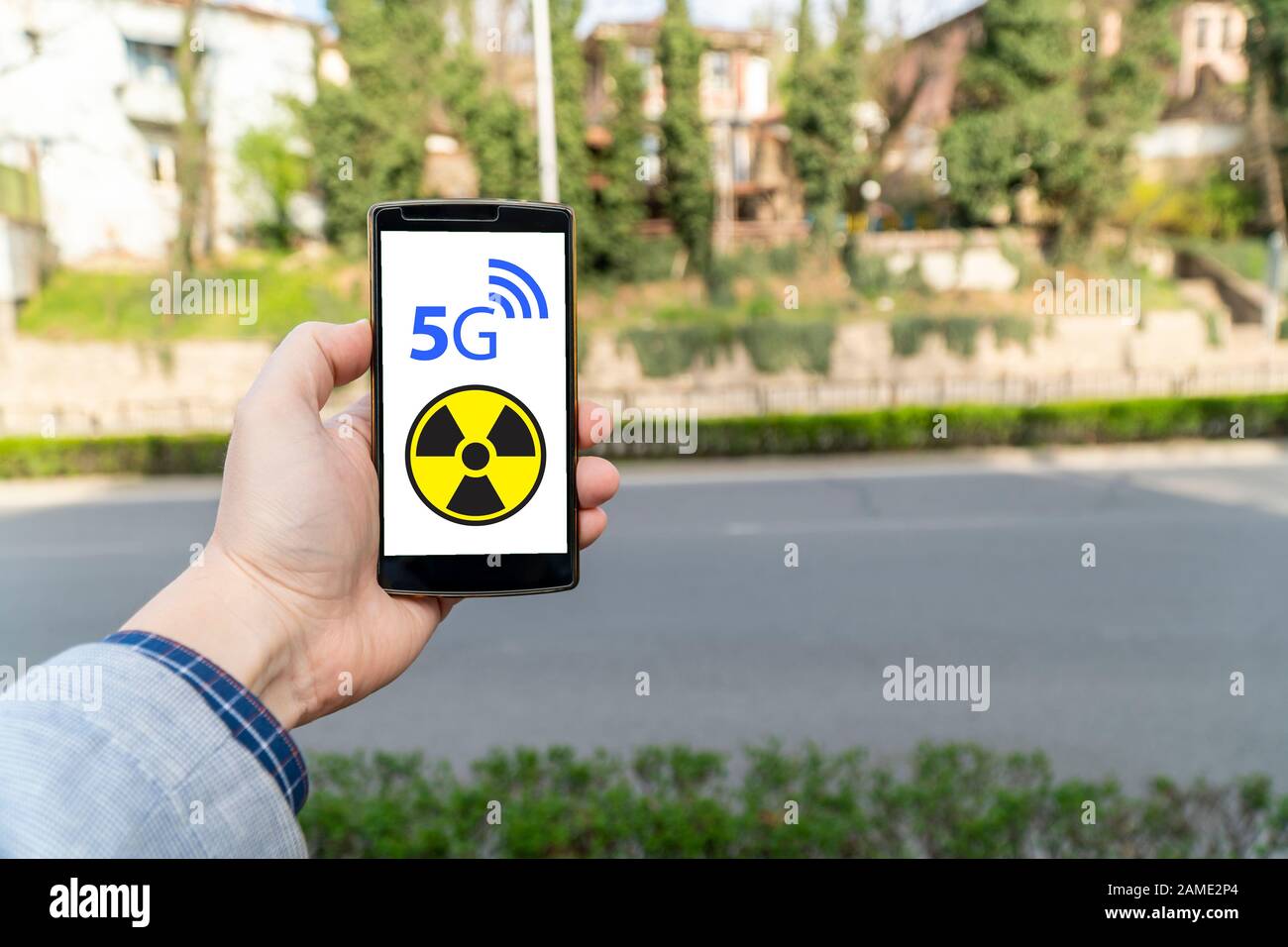 5g network danger on the street. Man holding smartphone with 5g and ...