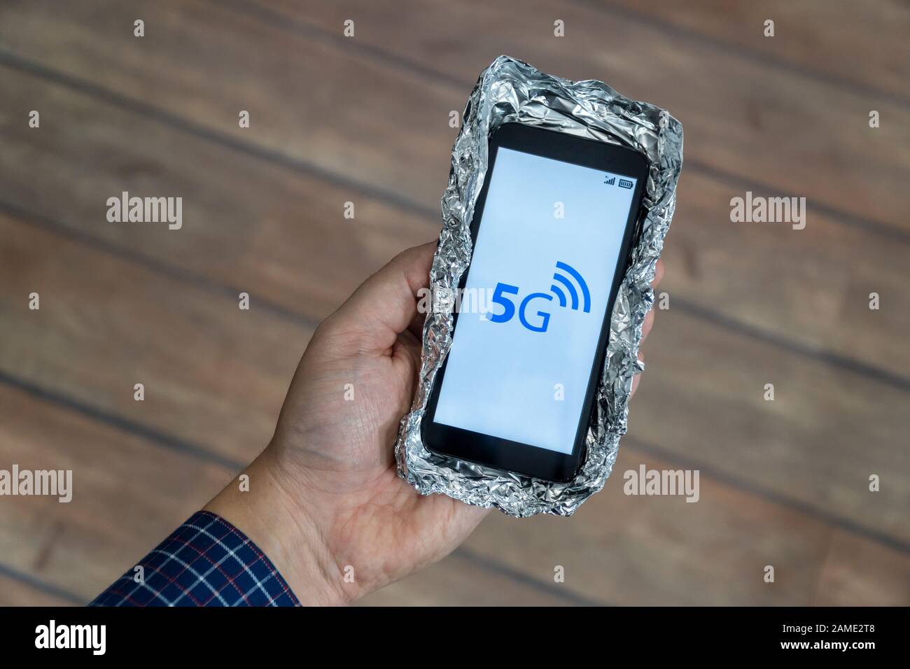 5g network danger concept. Smartphone with protective case made out of ...
